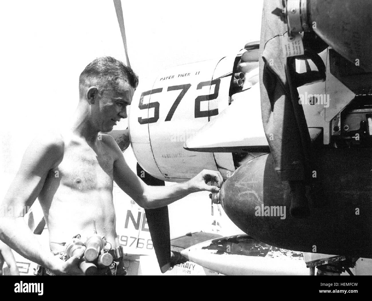 Bomb being fuzed on A-1H of VA-25 on USS Midway (CVA-41) 1965 Stock ...