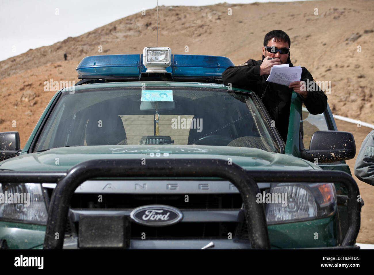 A member of the Afghan National Security Forces (ANSF) reads off an ...