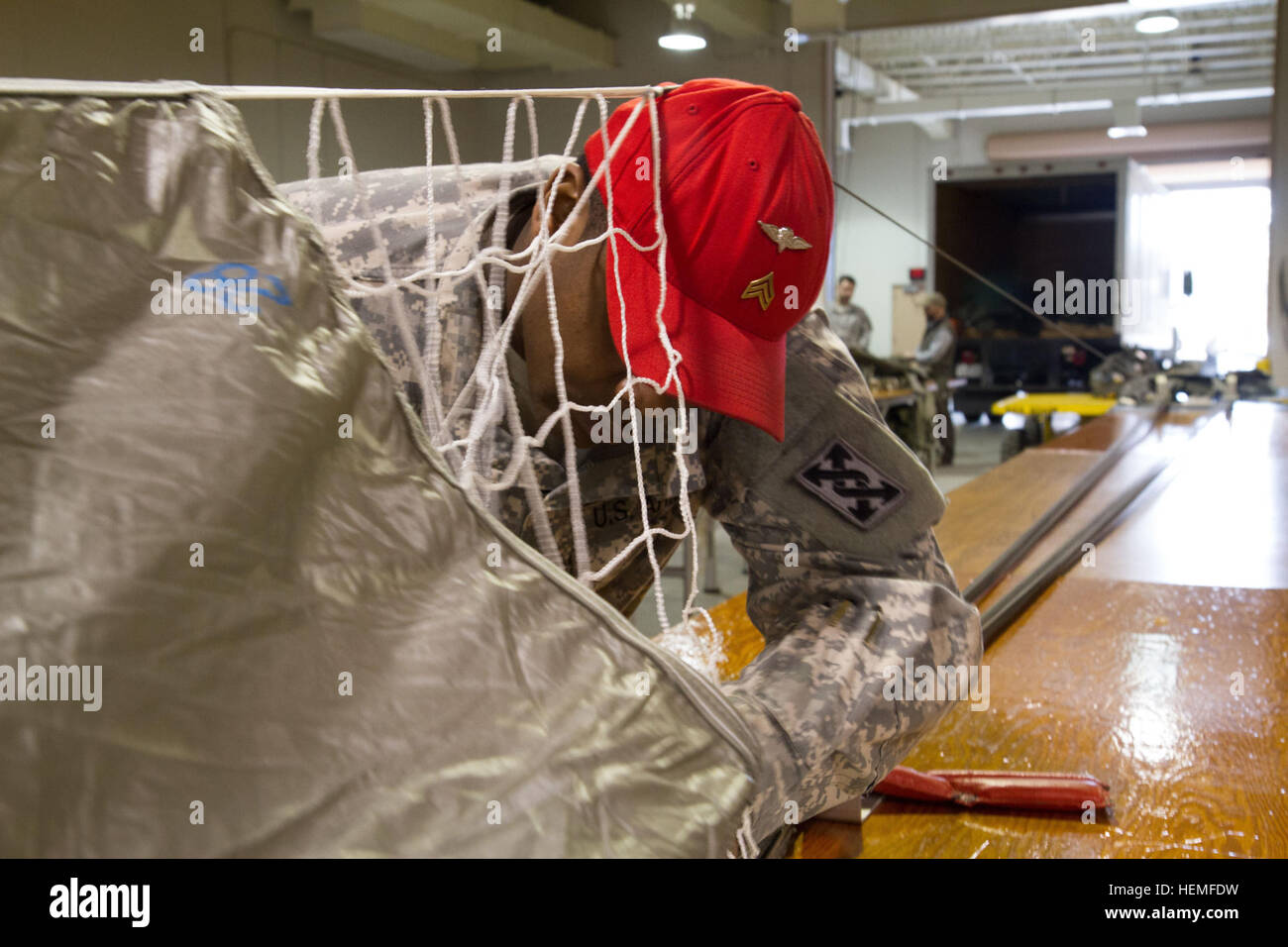 U.S. Army Reserve parachute riggers inspect MC6 parachutes at Fort ...