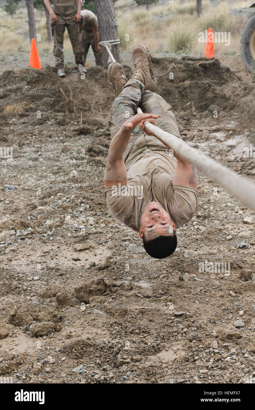 A U.S. Soldier slides across a 30-foot rope obstacle during the Mud Run ...