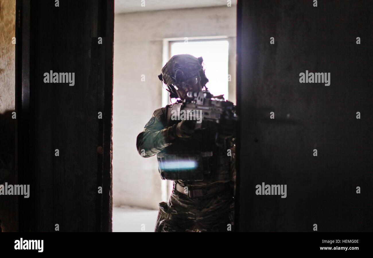 A coalition force member clears a room during a tactical training ...