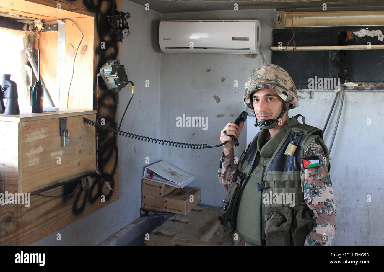 A Jordanian army soldier makes a radio check in a guard tower while ...