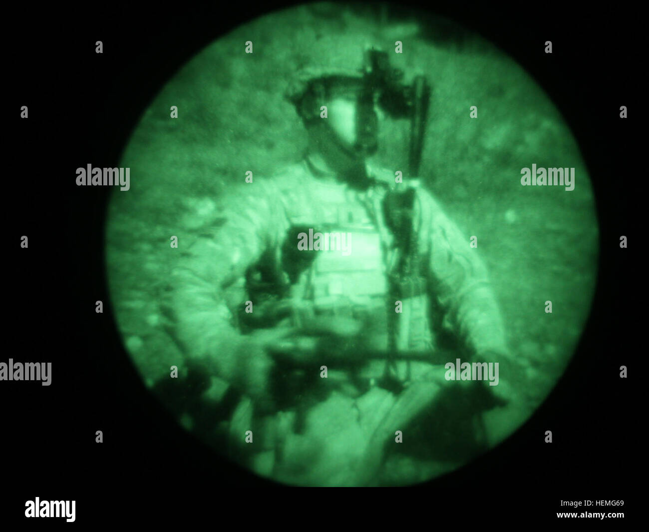 A U.S. Army fire support officer uses night optics to scan a landing ...