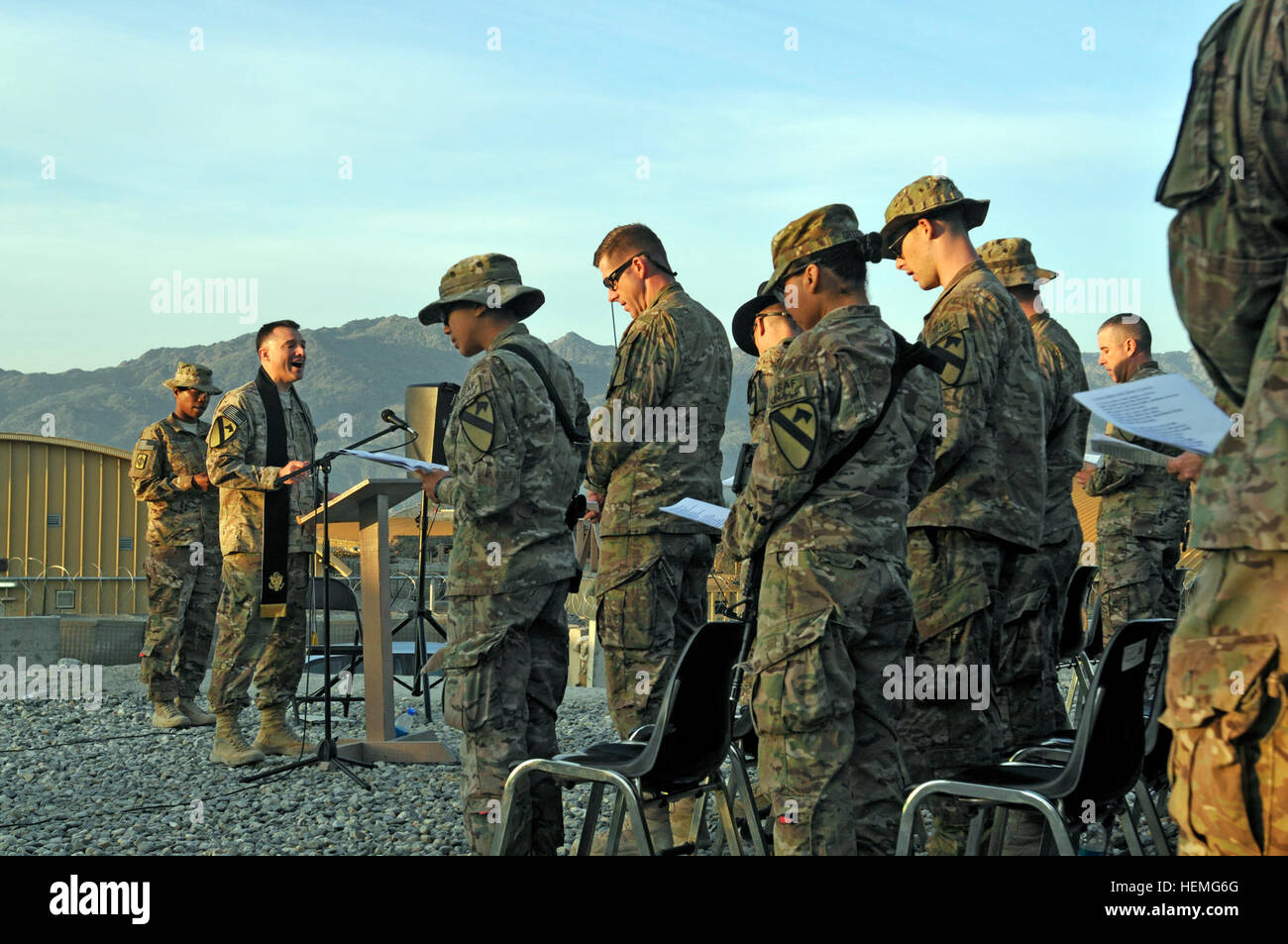 U.S. Army Maj. Steve Prost, at podium, leads his congregation in a hymn ...