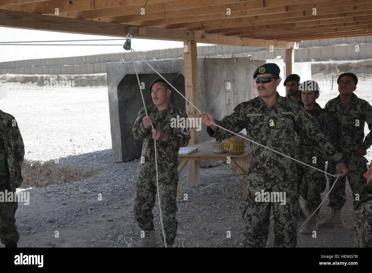 Afghan National Army soldiers use a pulley system to remove a simulated ...