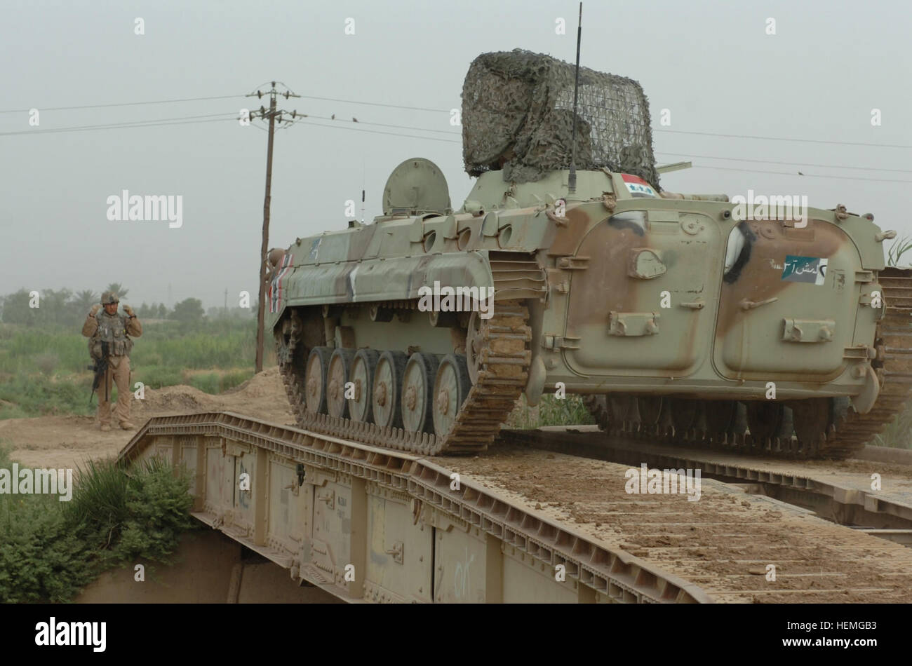 An Iraqi army soldier drives a BMP infantry fighting vehicle over a ...