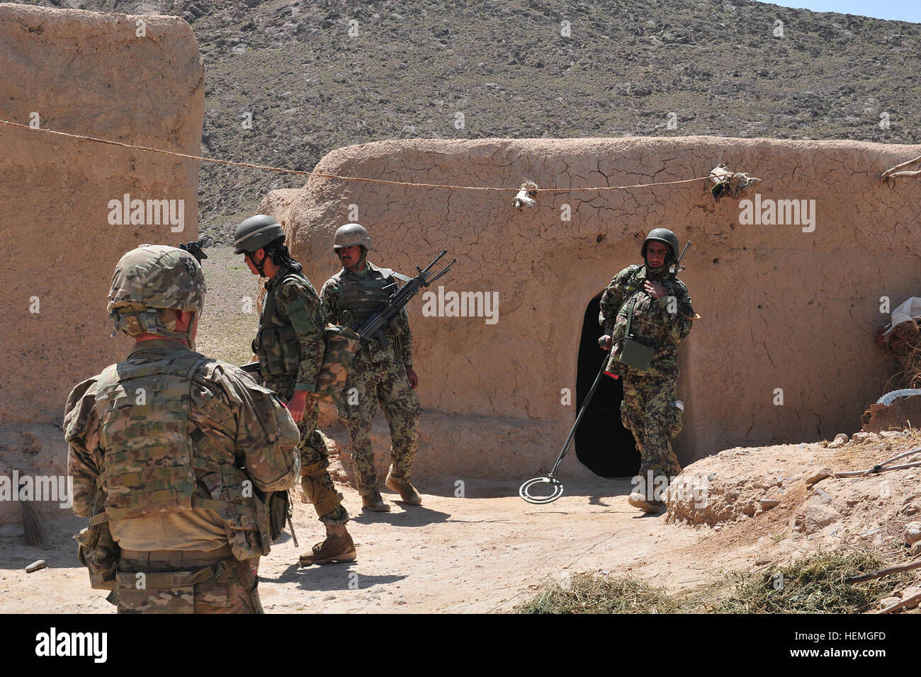 A U.S. Soldier, left, provides security as his Afghan counterparts ...