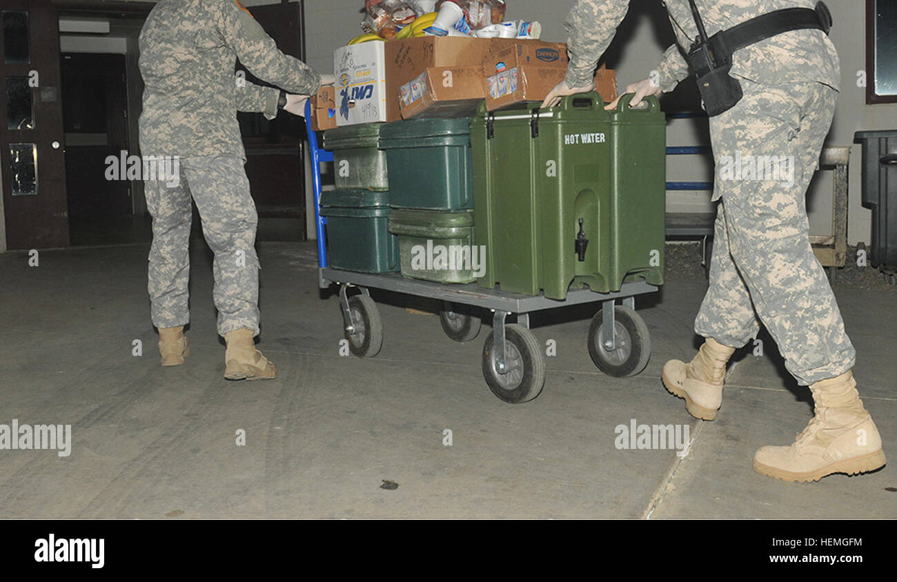 Guard Force soldiers unload and wheel in food items delivered to ...