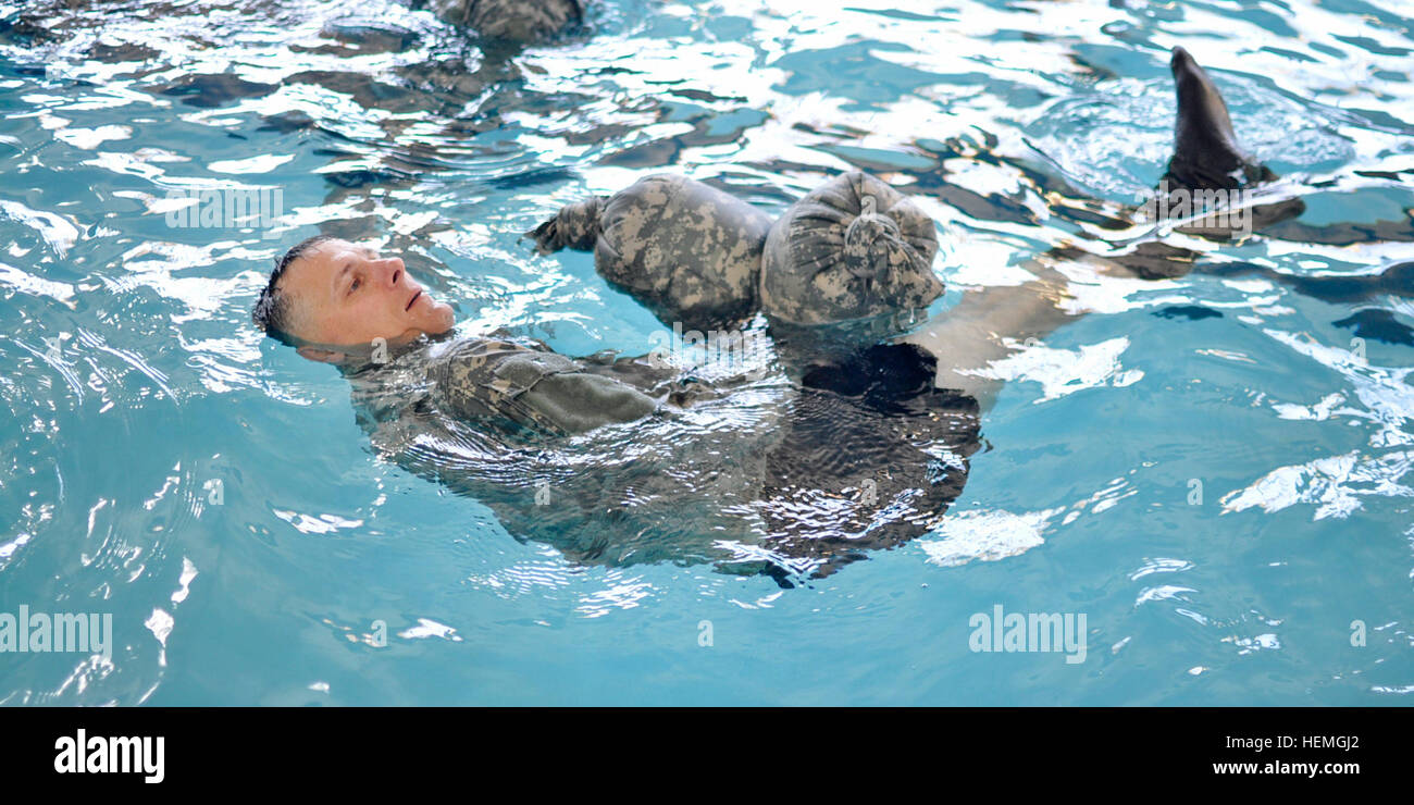 A Command Sergeant Major demonstrates using Army combat uniform ...