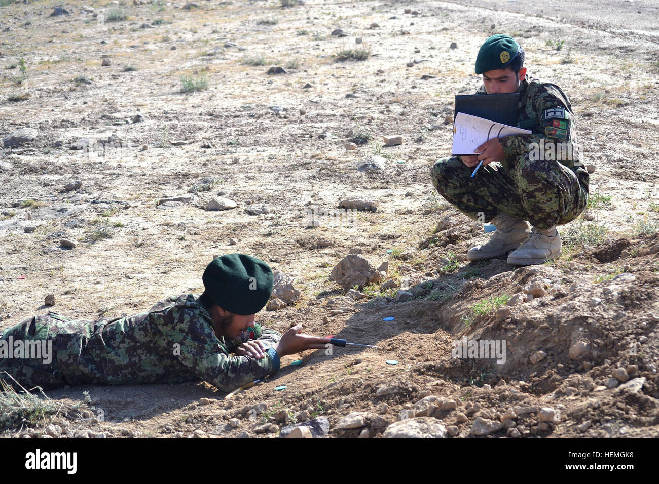 An Afghan National Army (ANA) soldier probes the ground looking for ...