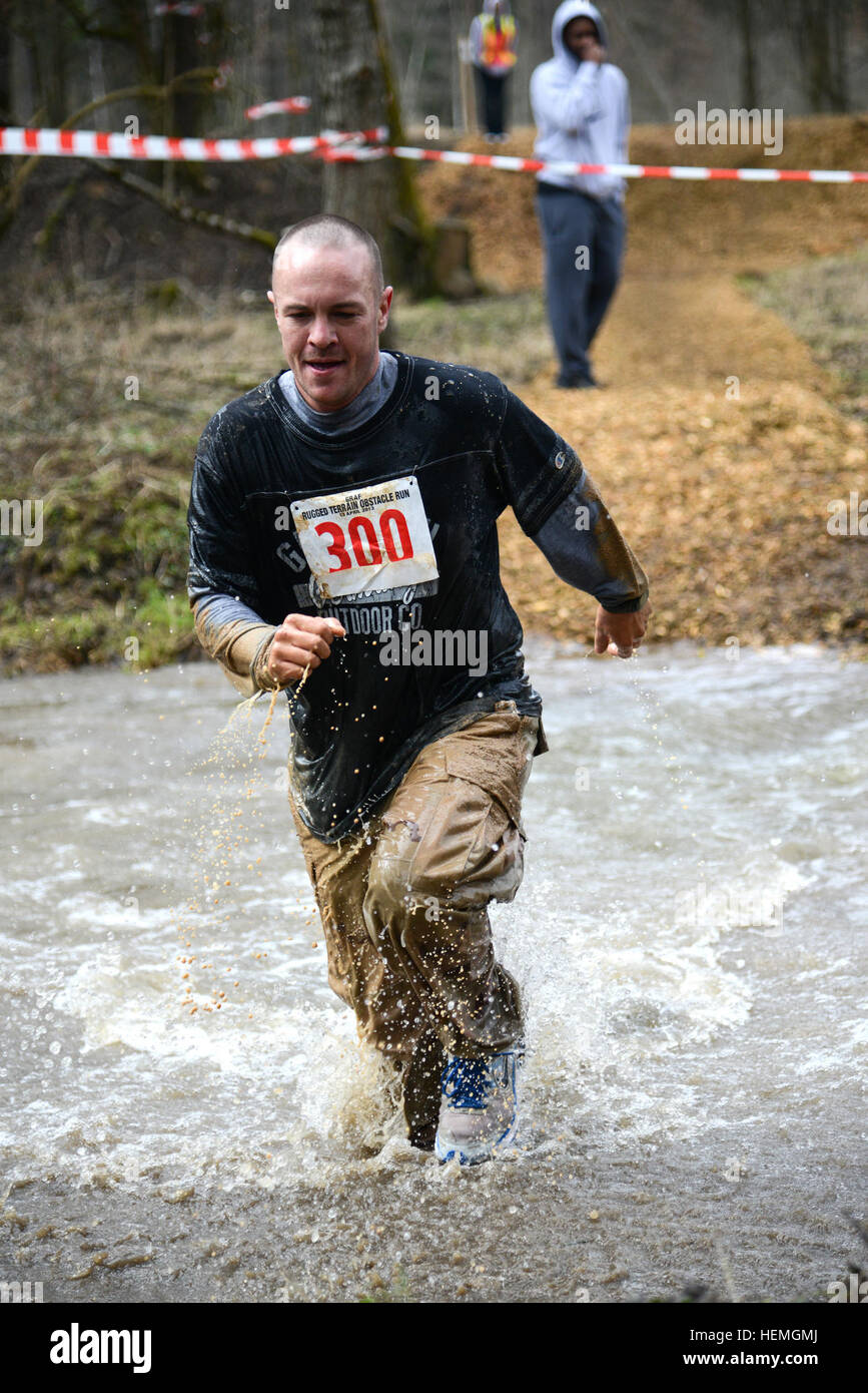 A competitor crosses a water obstacle during the inaugural Grafenwoehr ...