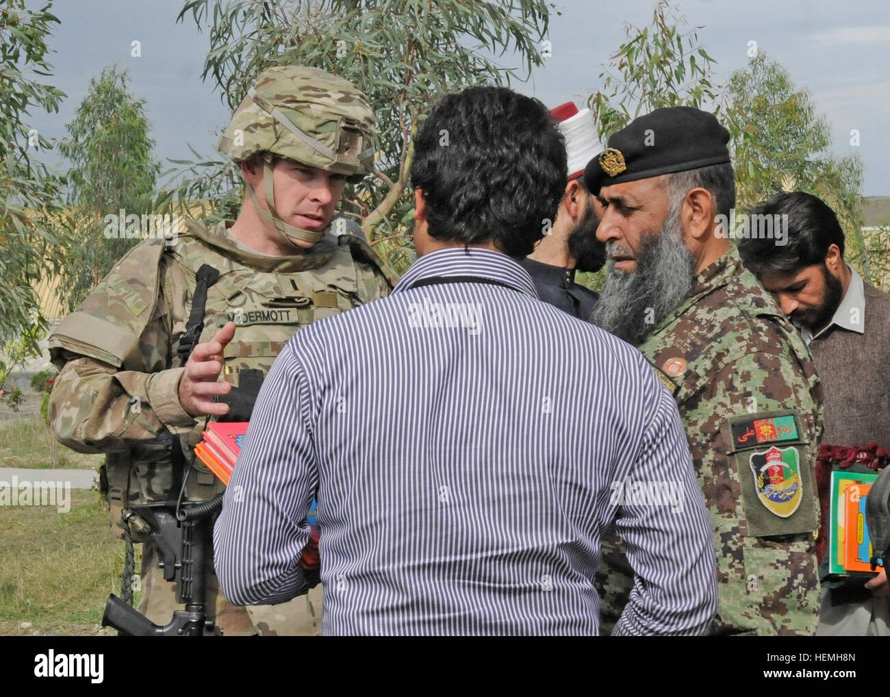 U.S. Army 1st Lt. James McDermott, left, speaks to an interpreter ...