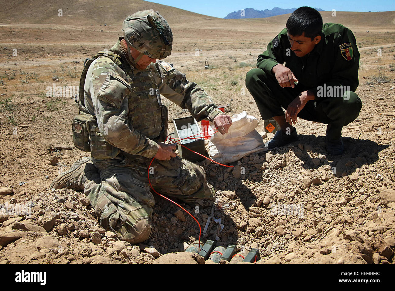 Explosive Ordnance Disposal personnel demonstrate attaching a ...
