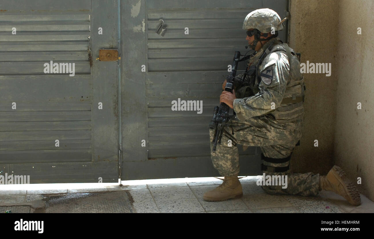 A U.S. Army platoon sergeant and medic provide security and medical ...