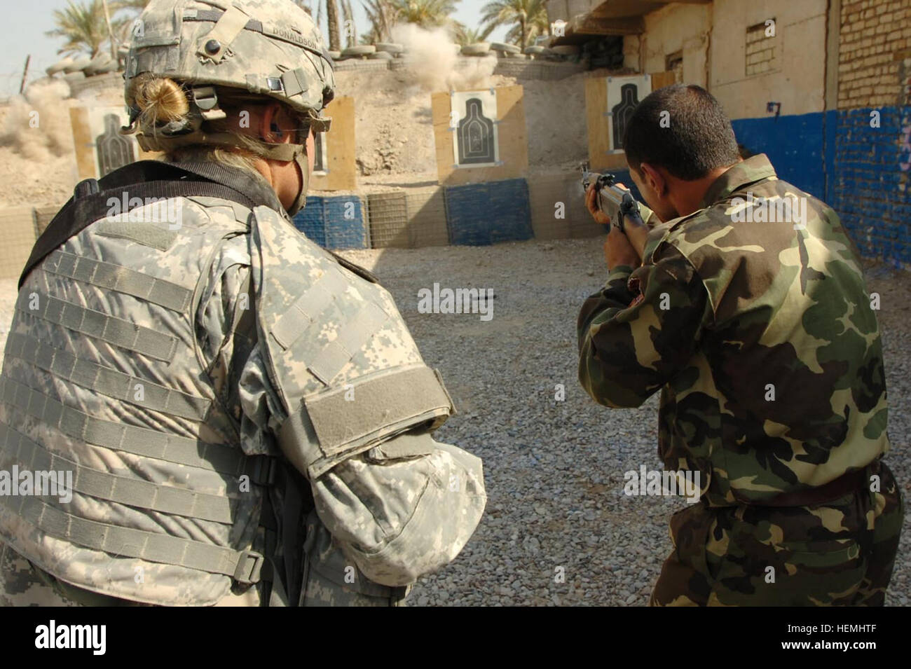 Iraqi police officers train at a weapons range in Tahrir, Baqubah, Iraq ...