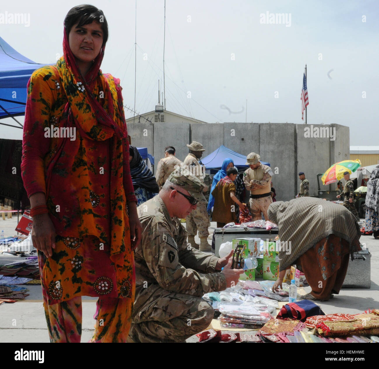 Young Afghan girls pose for a photo while participating in a Women's Bazaar on Camp Phoenix in ...