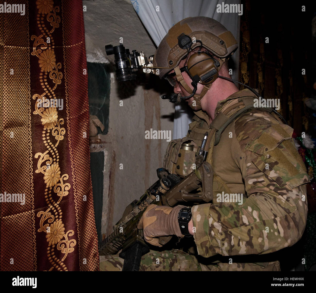 A member of an Afghan and coalition security force searches a Taliban ...