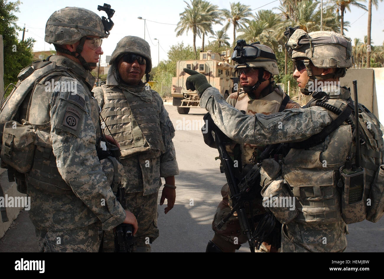 U.S. Army soldiers coordinate with an Iraqi squad leader and ...