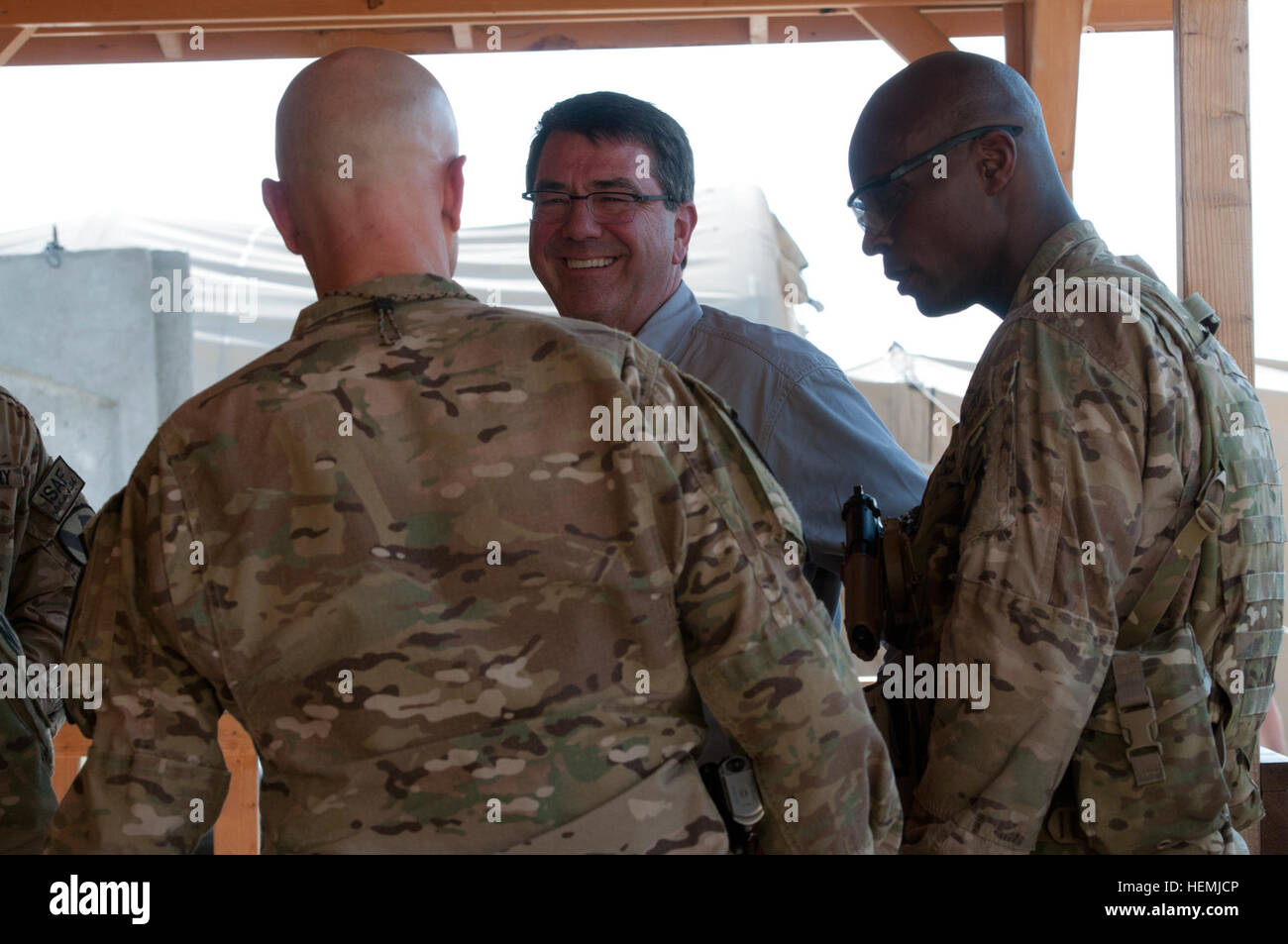U.S. Deputy Secretary of Defense Ashton B. Carter (center) shares a ...