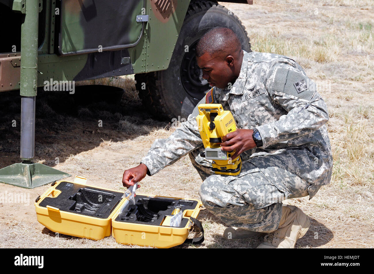 U.S. Army Spc. Nathaniel Harden assembles a Theodolite to survey the ...