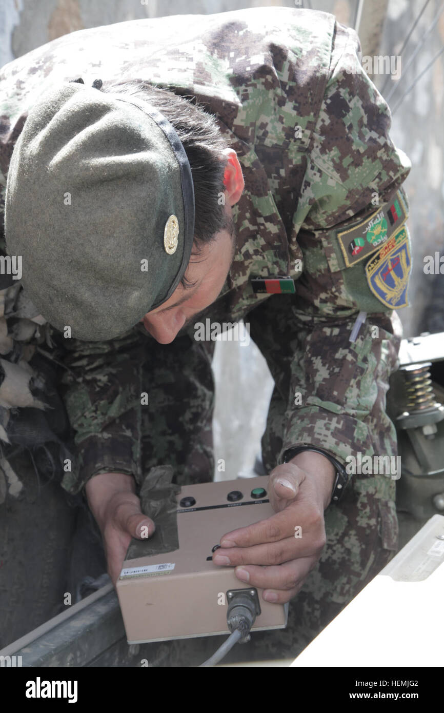 An Afghan National Army soldier conducts preventive maintenance checks ...