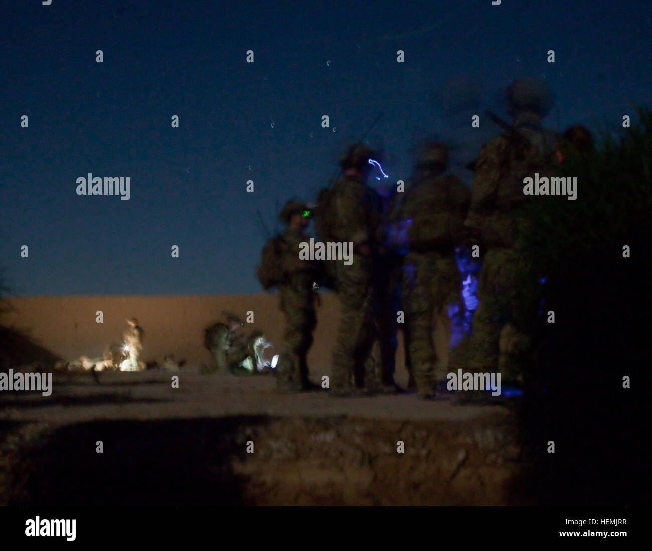 Members of an Afghan and coalition security force search the exterior ...