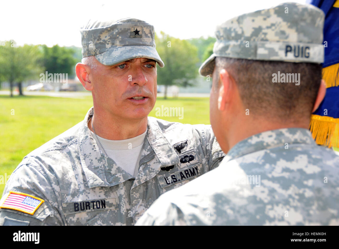 Brig. Gen. JB Burton passes the command colors to Command Sgt. Maj. David Puig during the 20th ...