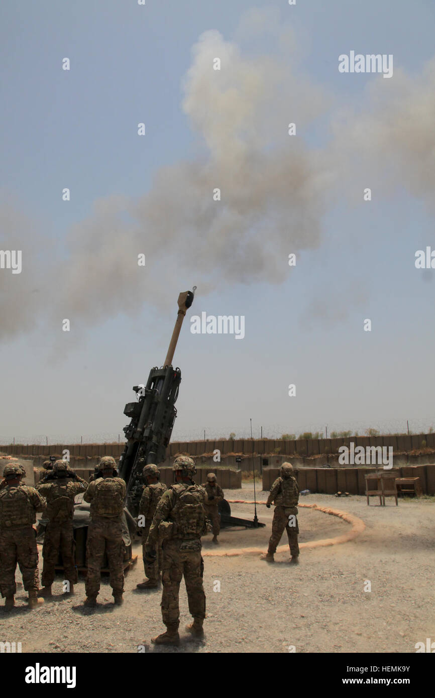 U.S. Army artillery soldiers load a 155 mm round into an M777 towed ...