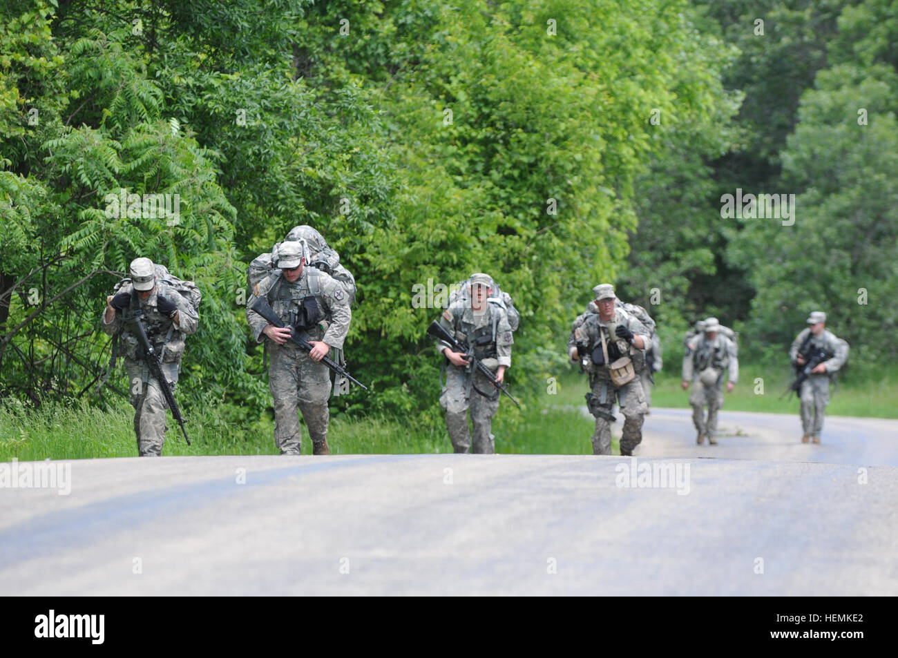 A team of combat engineers make their way up a hill during the 10-mile ...