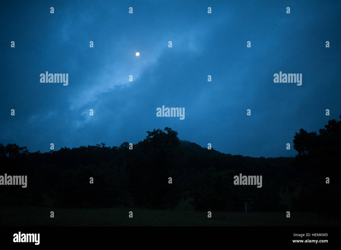 The super moon sets over a hilltop during the Night Land Navigation ...