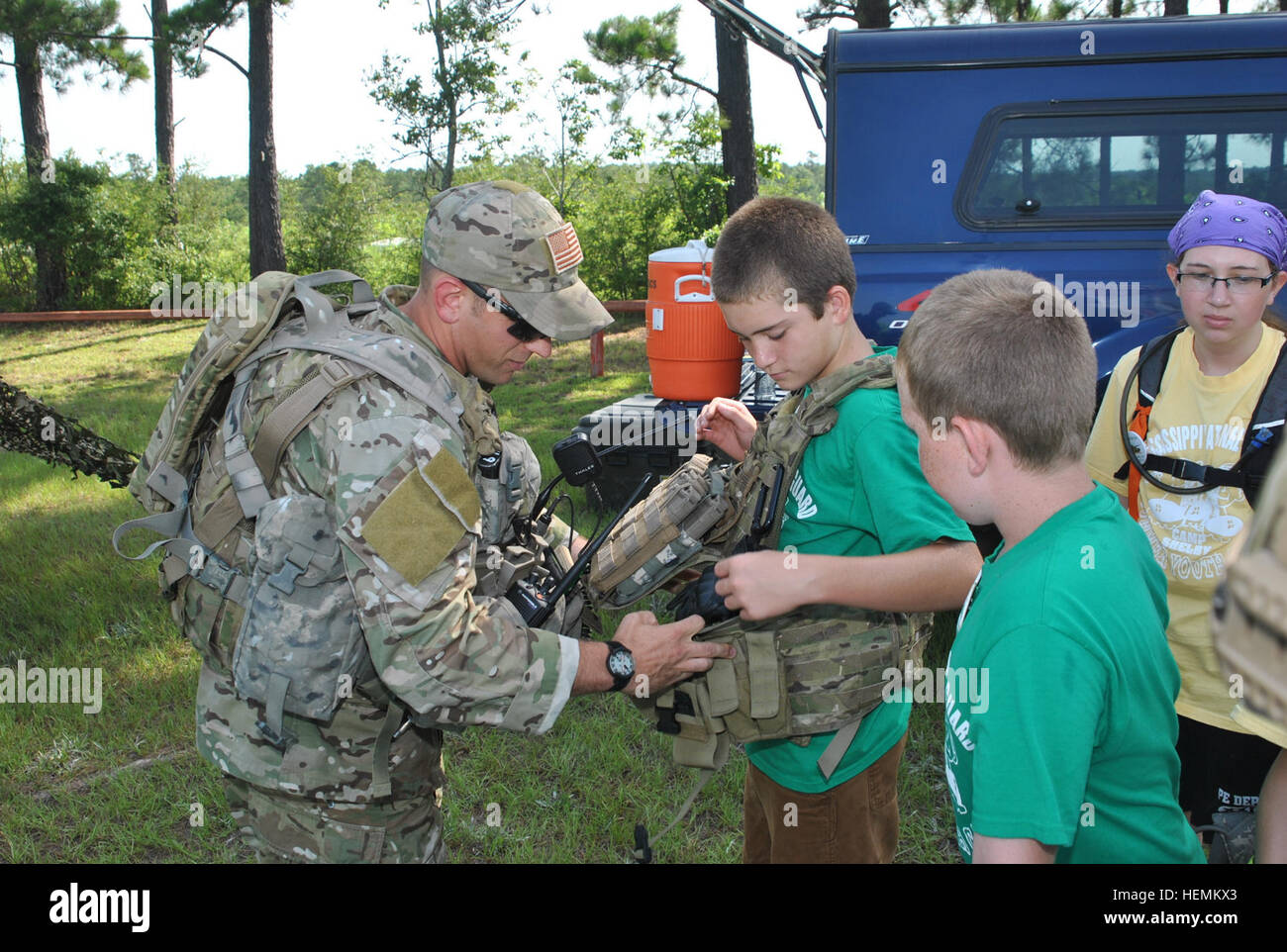 Air Force Master Sgt. Zachary Swan, of the 238th ASOS, adjusts the fit ...