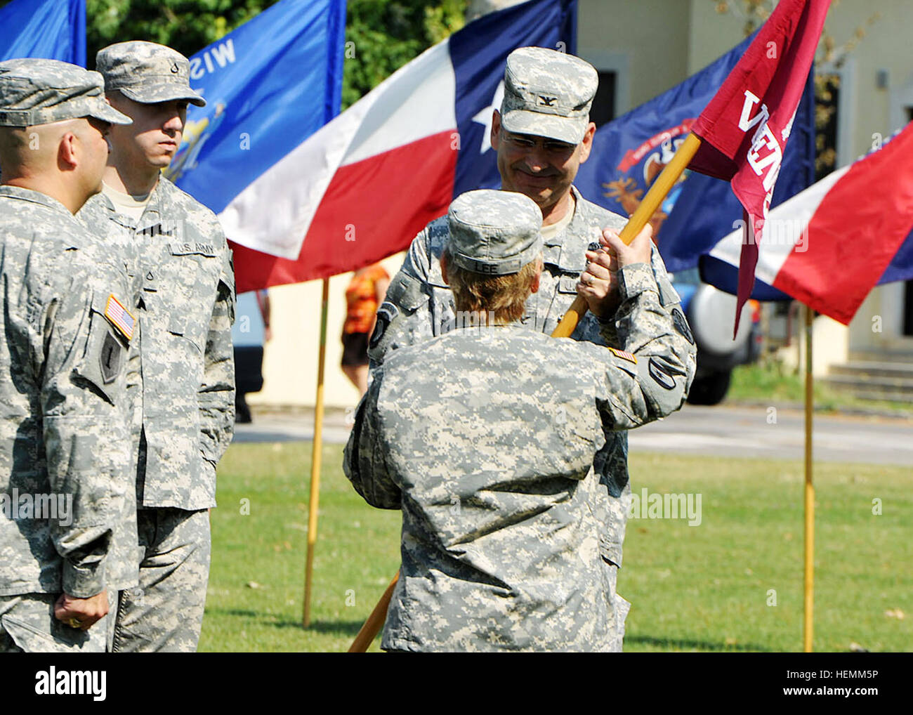 Col. Daniel W. Gall, outgoing commander, passes the guidon to Col ...