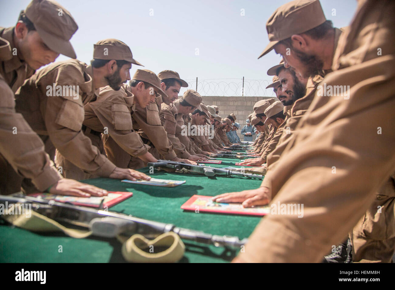 Newly graduated Afghan Local Police members lay their hands on the ...