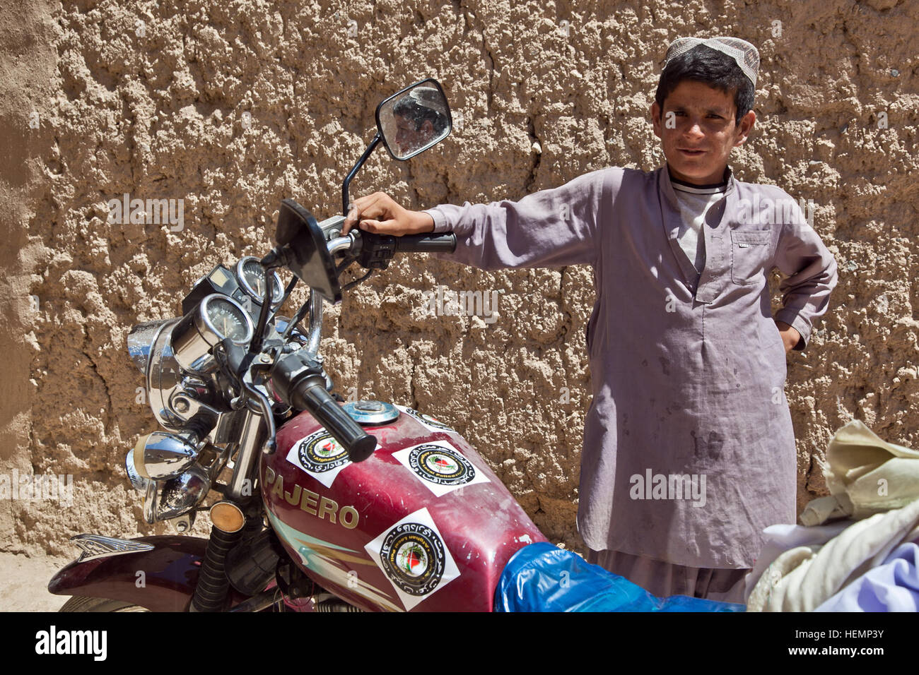 Afghan boy stands by a motorcycle after attending a medical seminar at ...