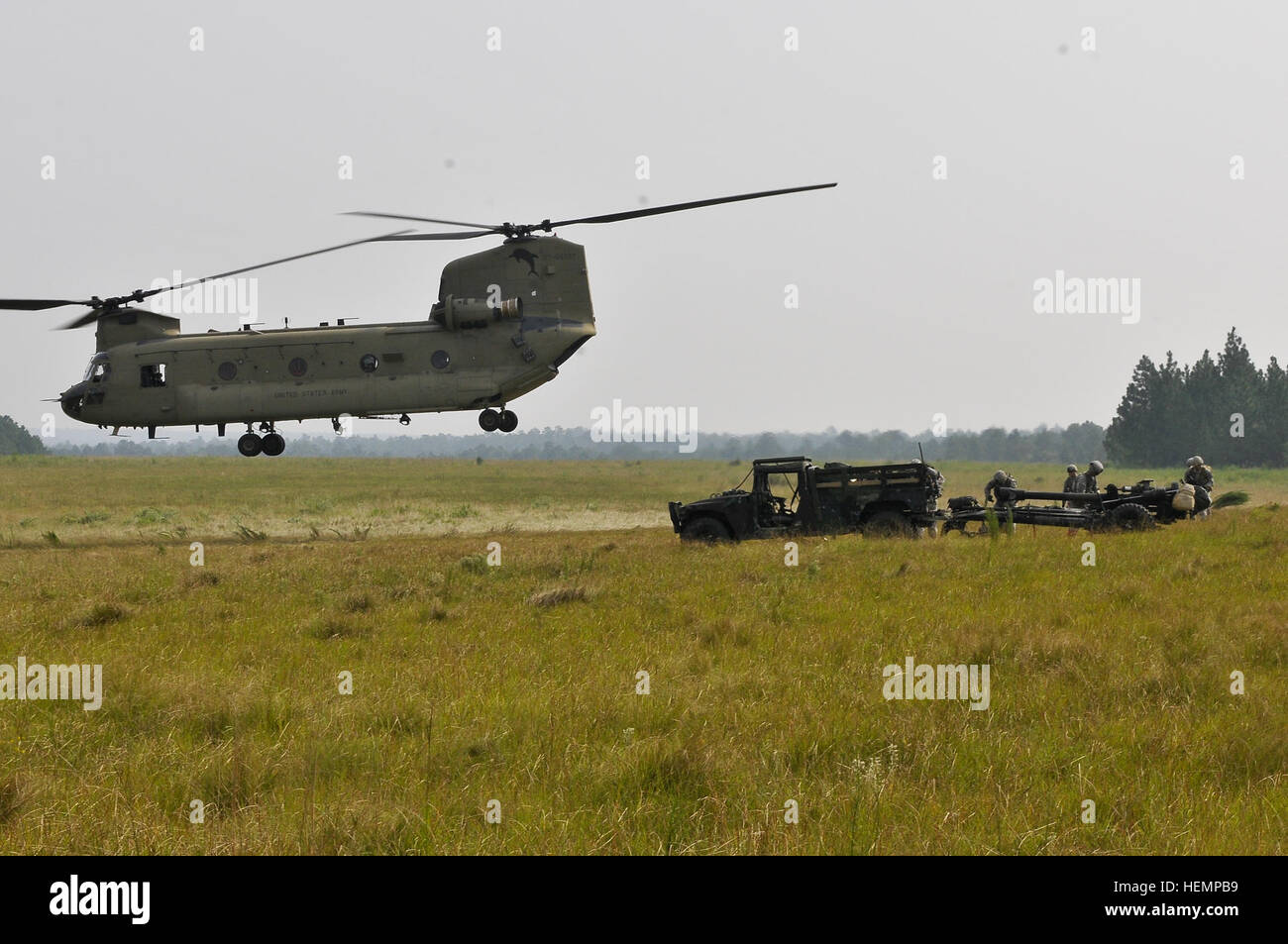 A CH-47 Chinook helicopter takes off after unloading a Humvee and M119 ...