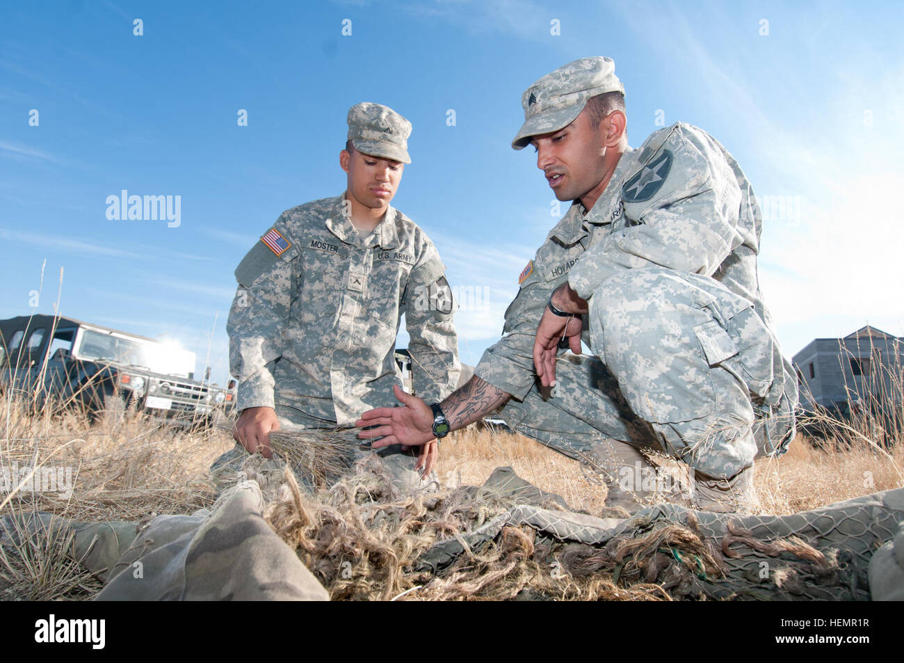 U.S. Army Sgt. Anthony Howard, right, a senior sniper, gives pointers ...