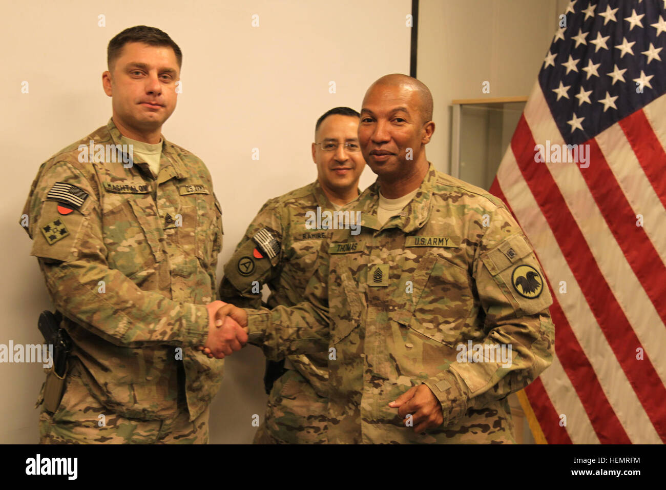U.S. Army Reserve Command Sgt. Maj. Luther Thomas Jr. presents a coin ...