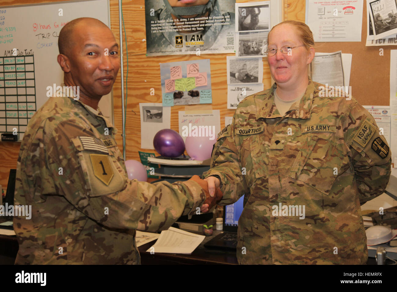 U.S. Army Reserve Command Sgt. Maj. Luther Thomas Jr. presents a coin ...