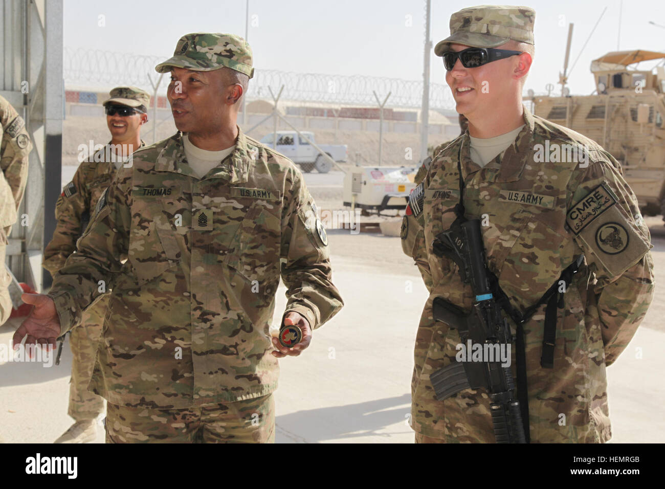 U.S. Army Reserve Command Sgt. Maj. Luther Thomas Jr. presents a coin ...