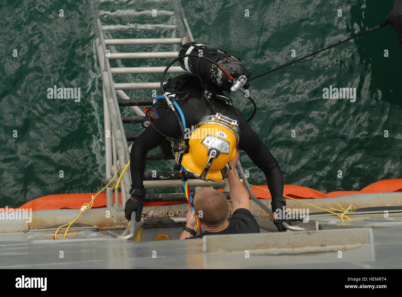 A Soldier with the 7th Dive Detachment, 130th Engineer Brigade, lowers ...