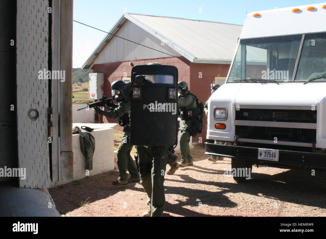 Fort Carson police Special Reaction Team members move to enter a ...
