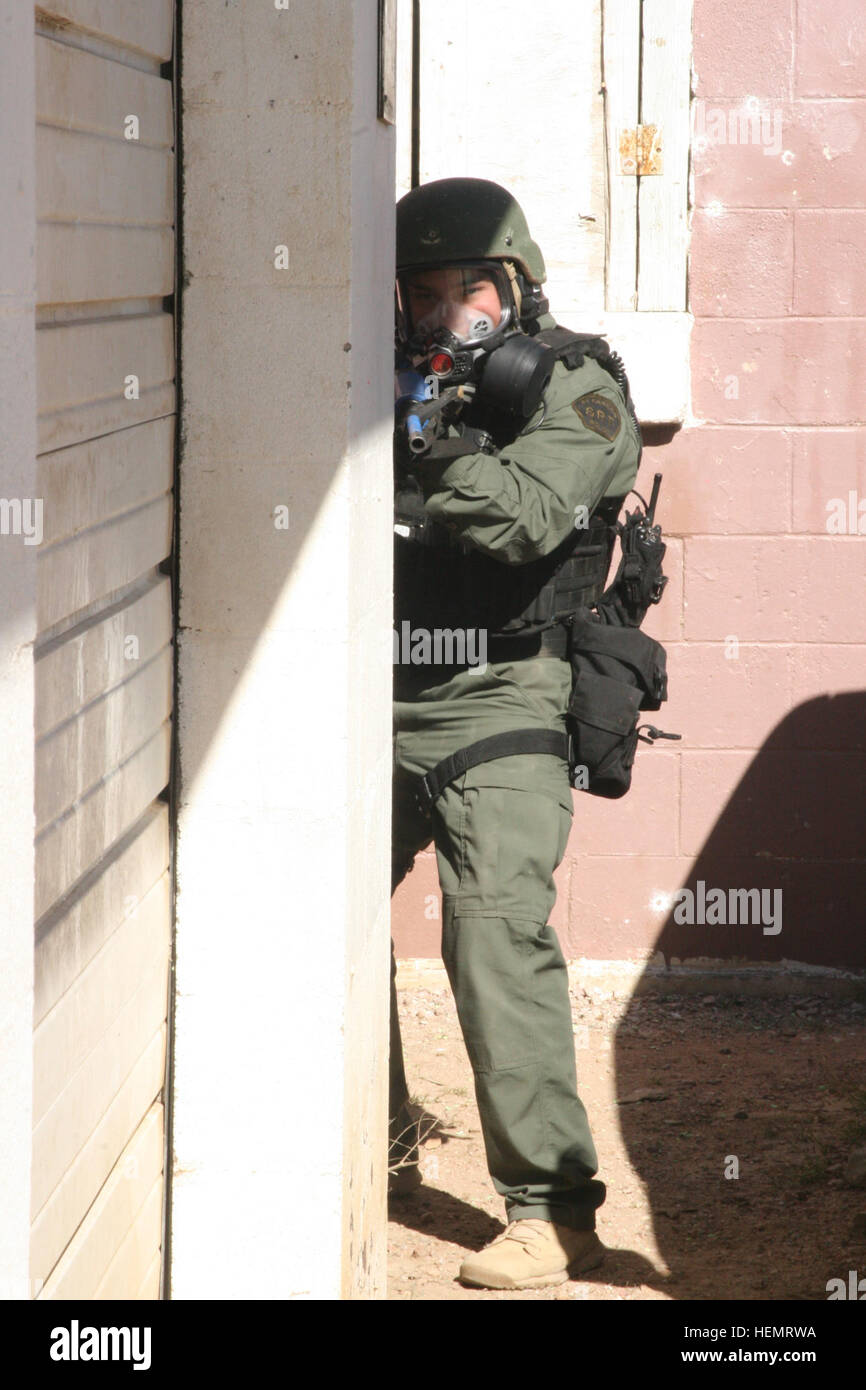 A member of the Fort Carson police Special Reaction team provides cover ...