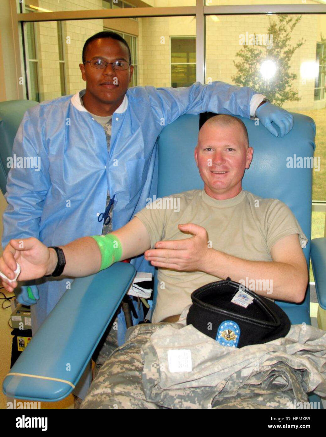 SFC Ramon Quinones collects a blood donation from SGT James Borders at ...