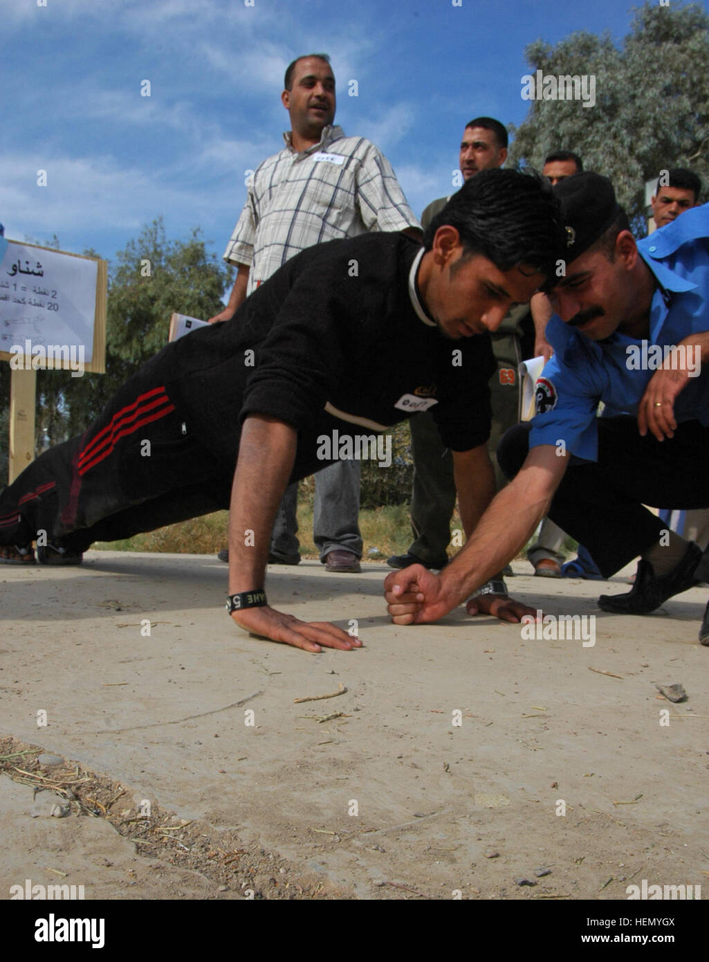 An Iraqi Policeman holds his fist down to insure an Iraqi Police ...