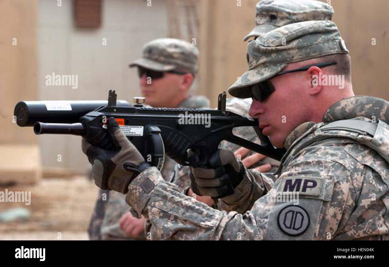 Military Policeman aims a 'less-lethal' weapon Stock Photo - Alamy