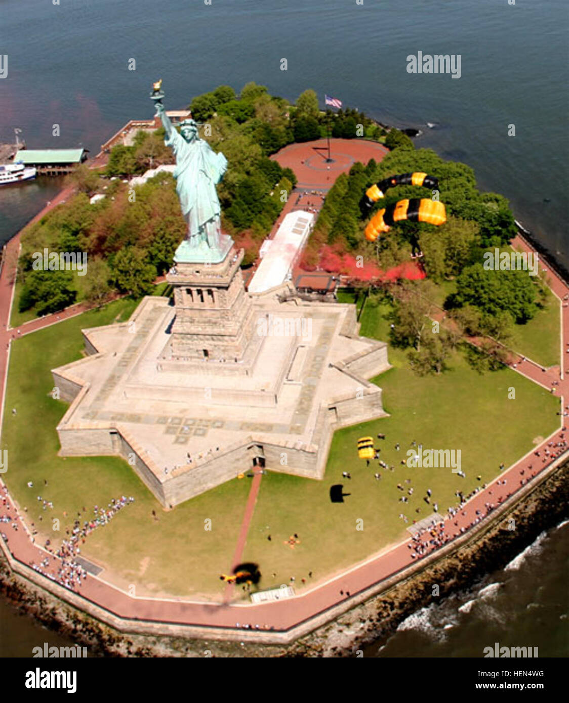 The U.S. Army Golden Knights parachute team lands at the Statue of ...