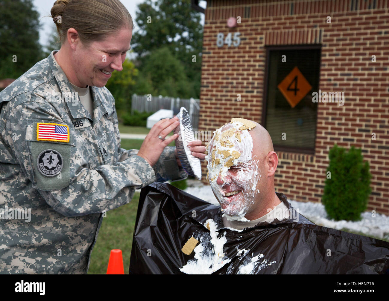 U.S. Army Staff Sgt. Tracy Jacobs pulls away the pie tin after hitting ...