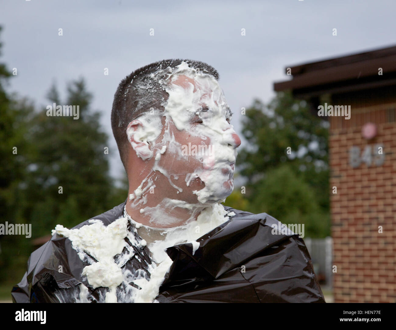 U.S. Army Sgt. Robert Sheets turns to show the pie all over his face ...