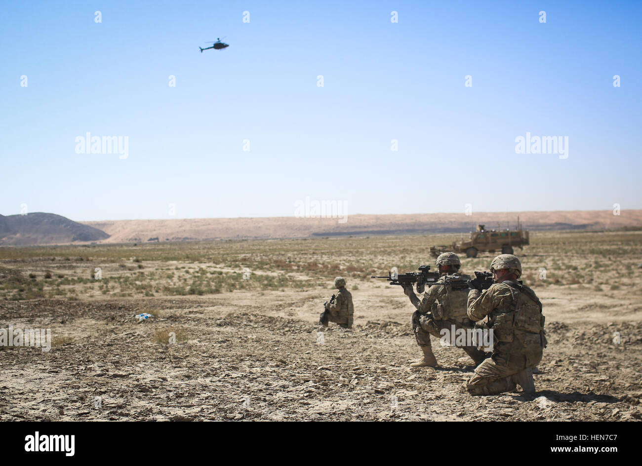 Soldiers assigned to Task Force Dragoon, provide security while an area ...