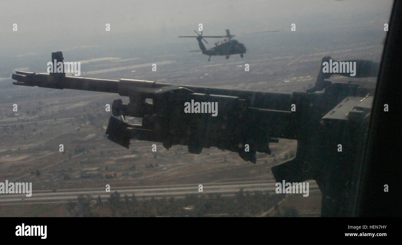 Two U.S. Army Black Hawk helicopters conduct aerial operations over a ...